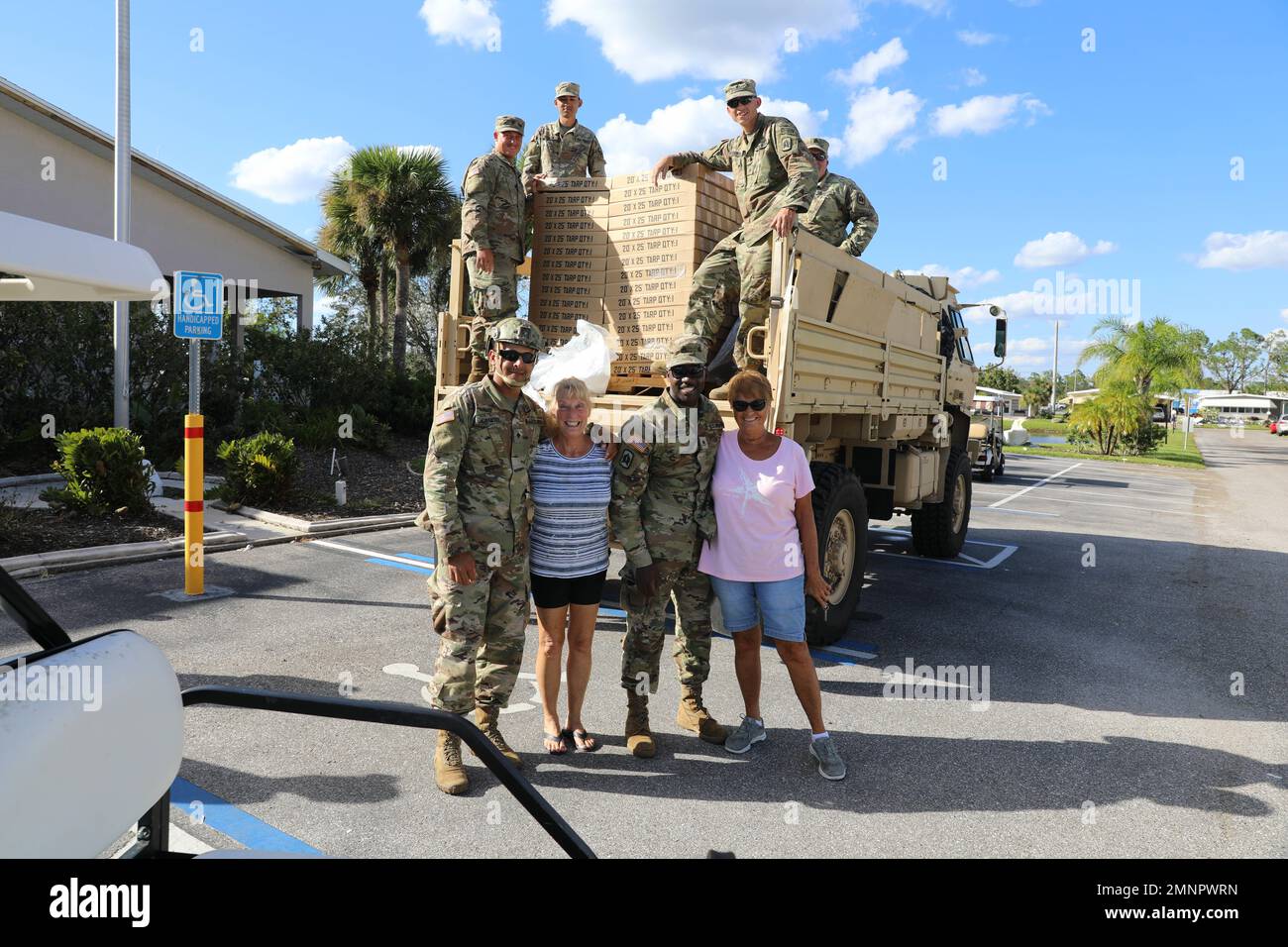 Soldiers with the 1-265th Air Defense Artillery (ADA), deliver aid to ...