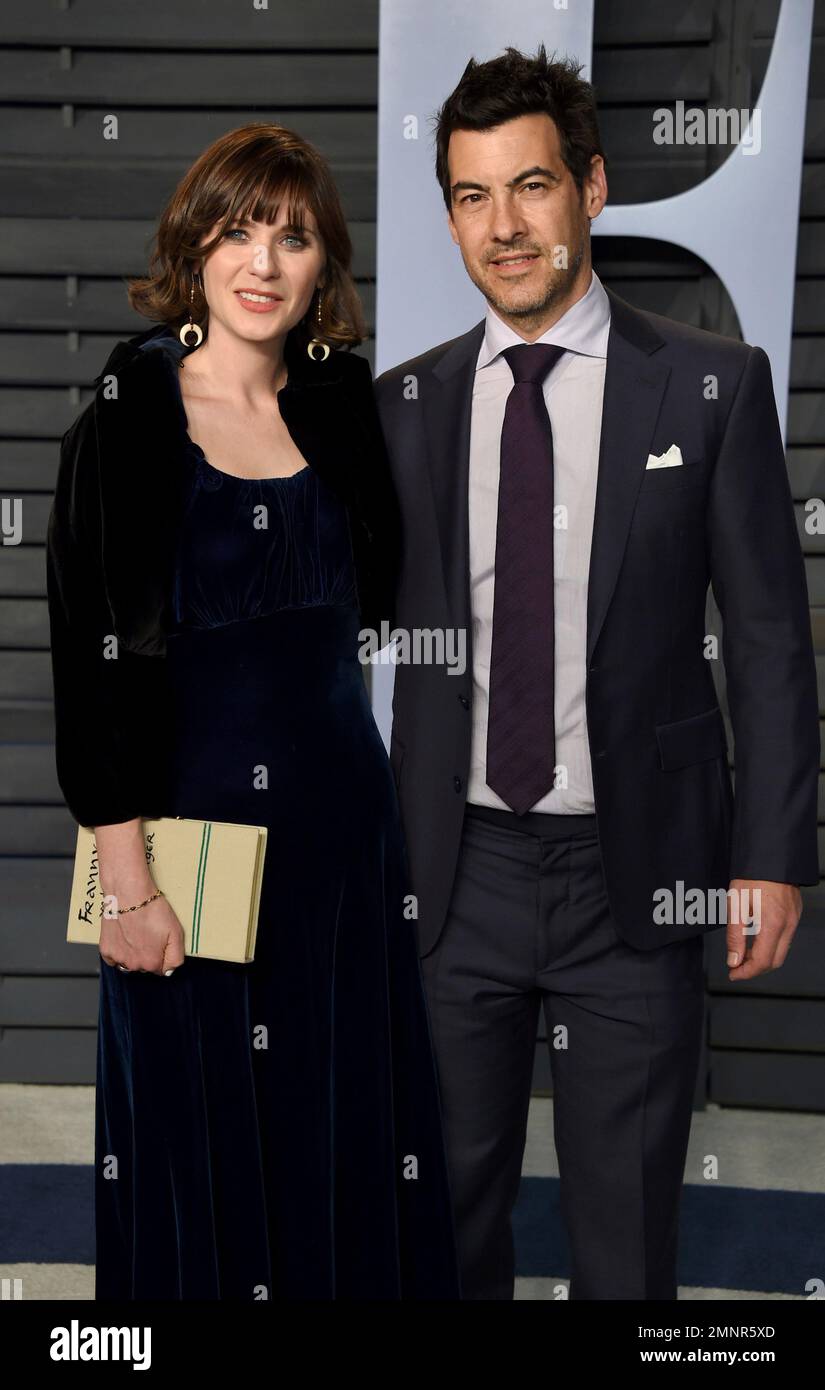 Zooey Deschanel, left, and Jacob Pechenik arrive at the Vanity Fair ...