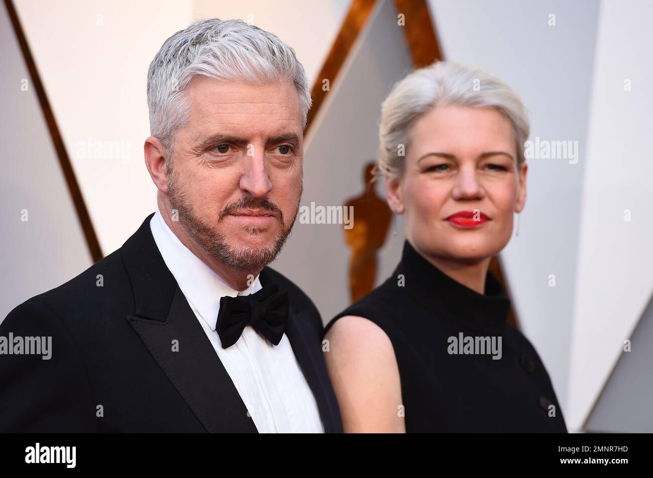 Anthony McCarten, left, and Eva Maywald arrive at the Oscars on Sunday ...