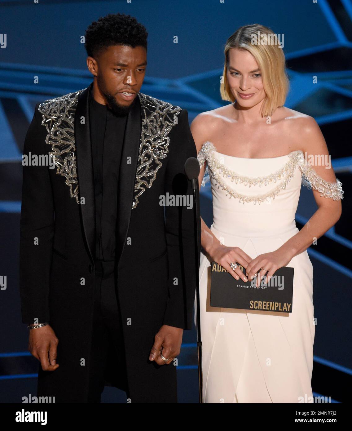 Chadwick Boseman, left, and Margot Robbie present the award for best ...