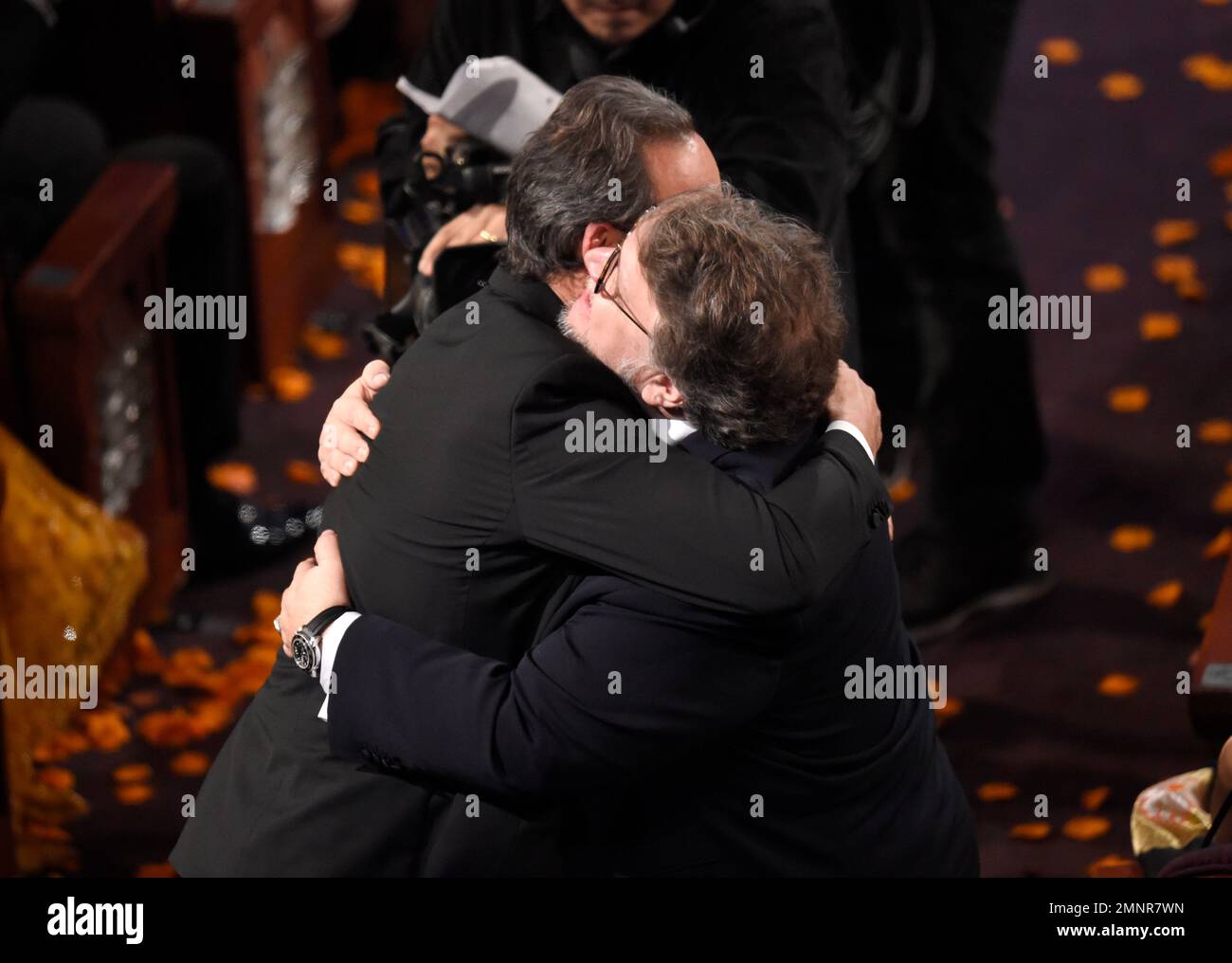 Guillermo del Toro, right, embraces Alexandre Desplat in the audience ...