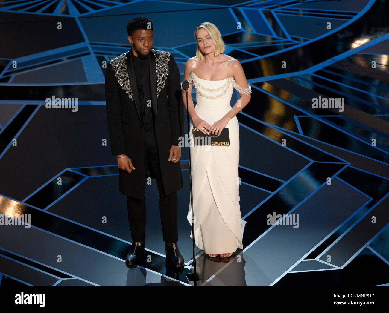 Chadwick Boseman, left, and Margot Robbie present the award for best ...