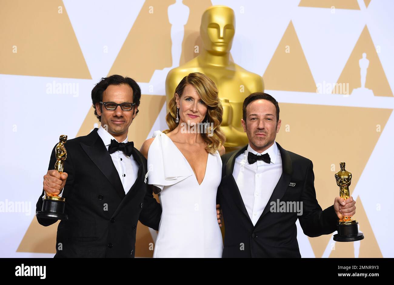 Presenter Laura Dern, center, poses with Dan Cogan, left, and Bryan ...
