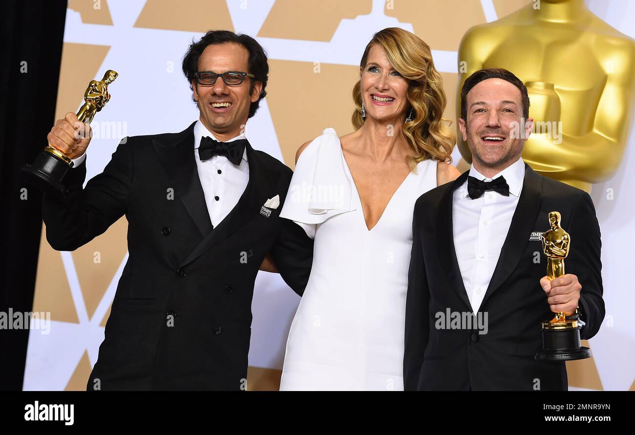 Presenter Laura Dern, center, poses with Dan Cogan, left, and Bryan ...