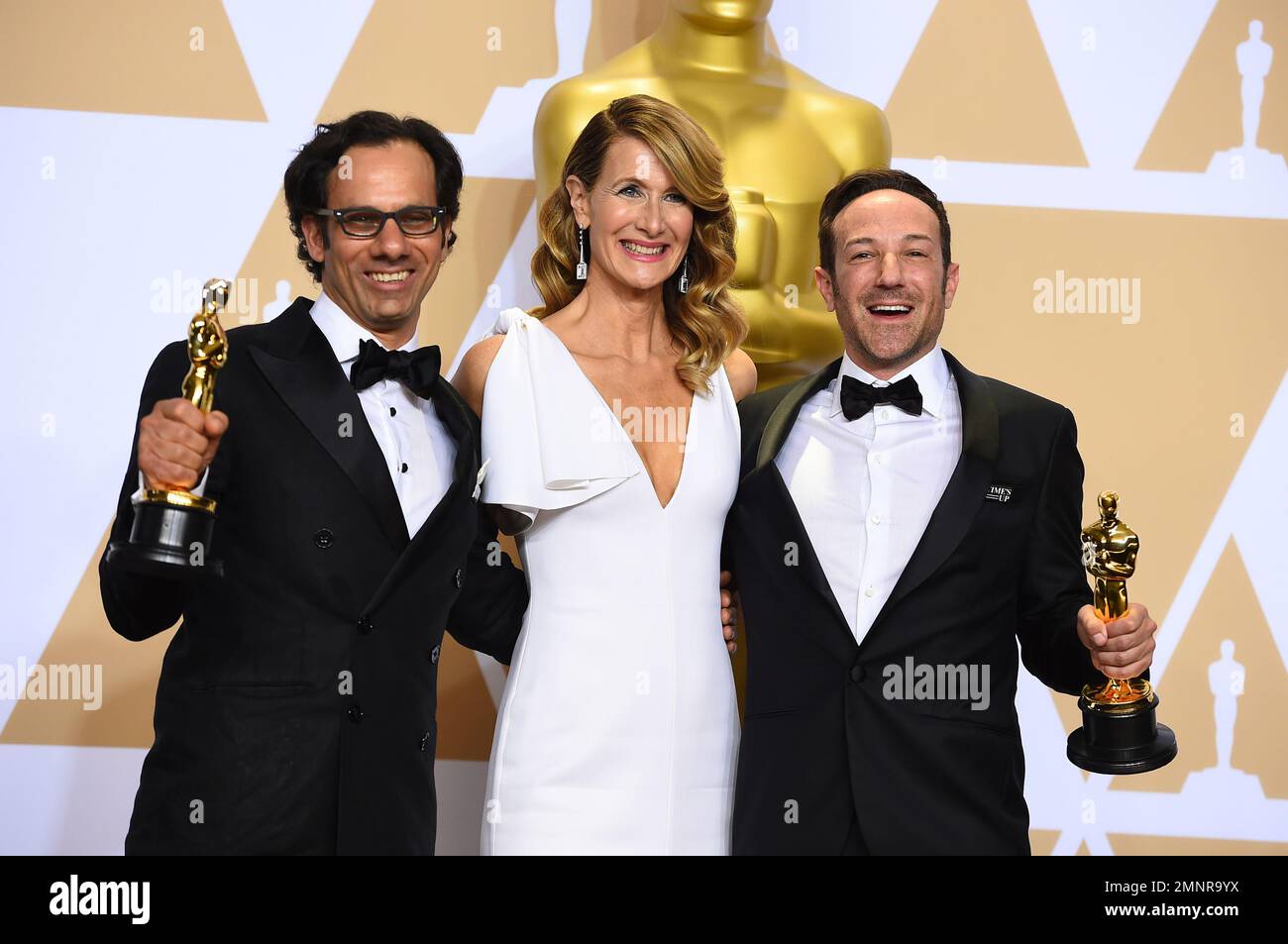 Presenter Laura Dern, center, poses with Dan Cogan, left, and Bryan ...