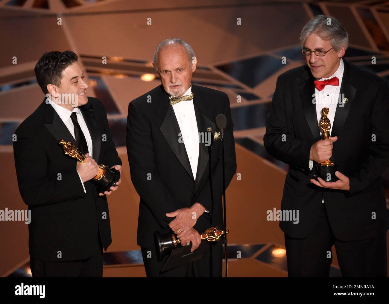 Gary A. Rizzo, from left, Gregg Landaker, and Mark Weingarten accept ...