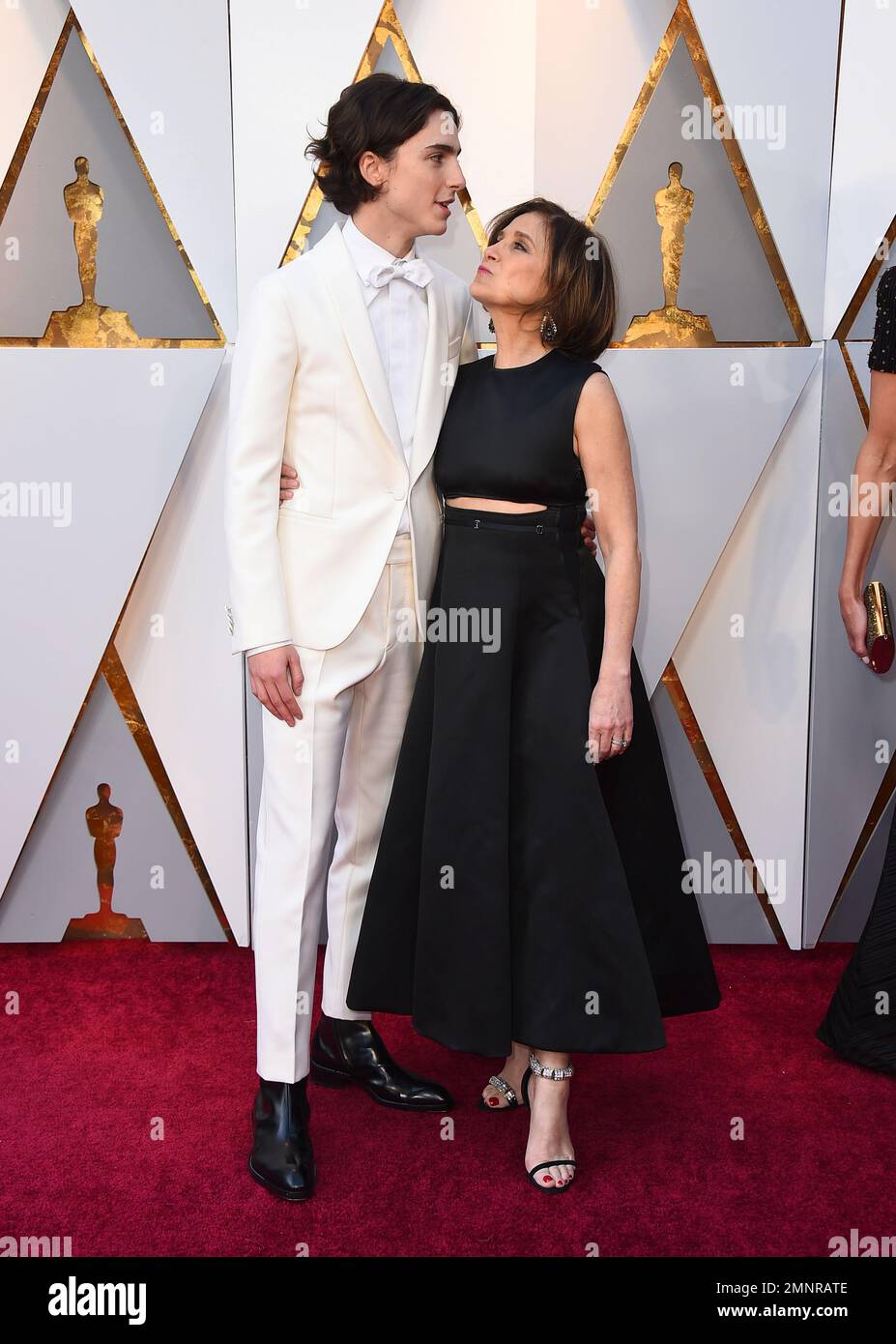 Timothee Chalamet, left, and Nicole Flender arrive at the Oscars on ...