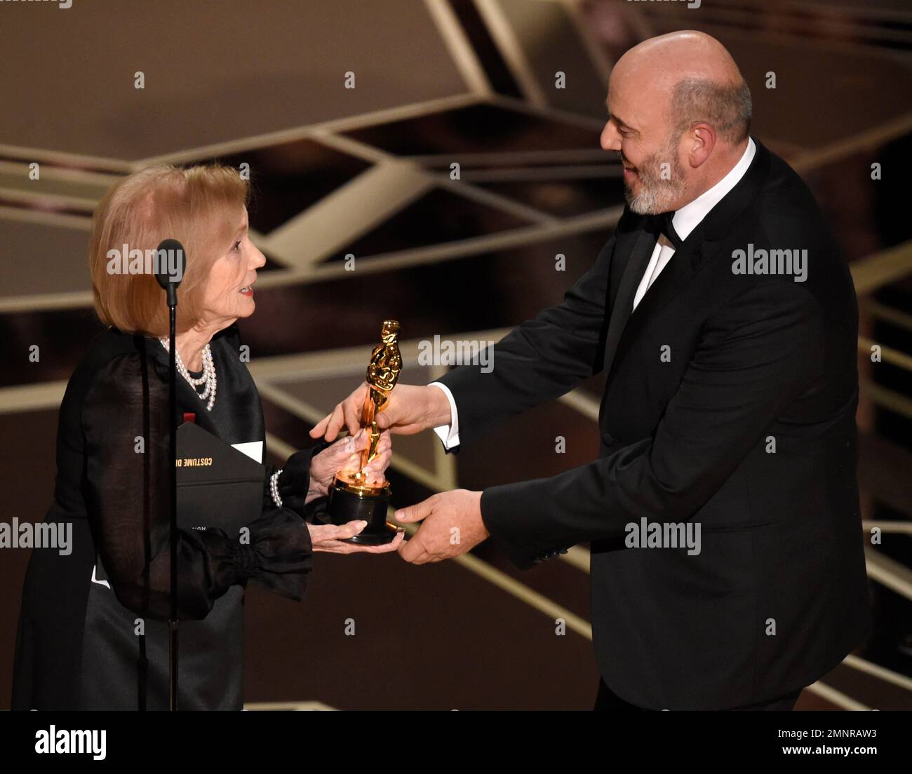 Eva Marie Saint, left, presents Mark Bridges with the award for best ...