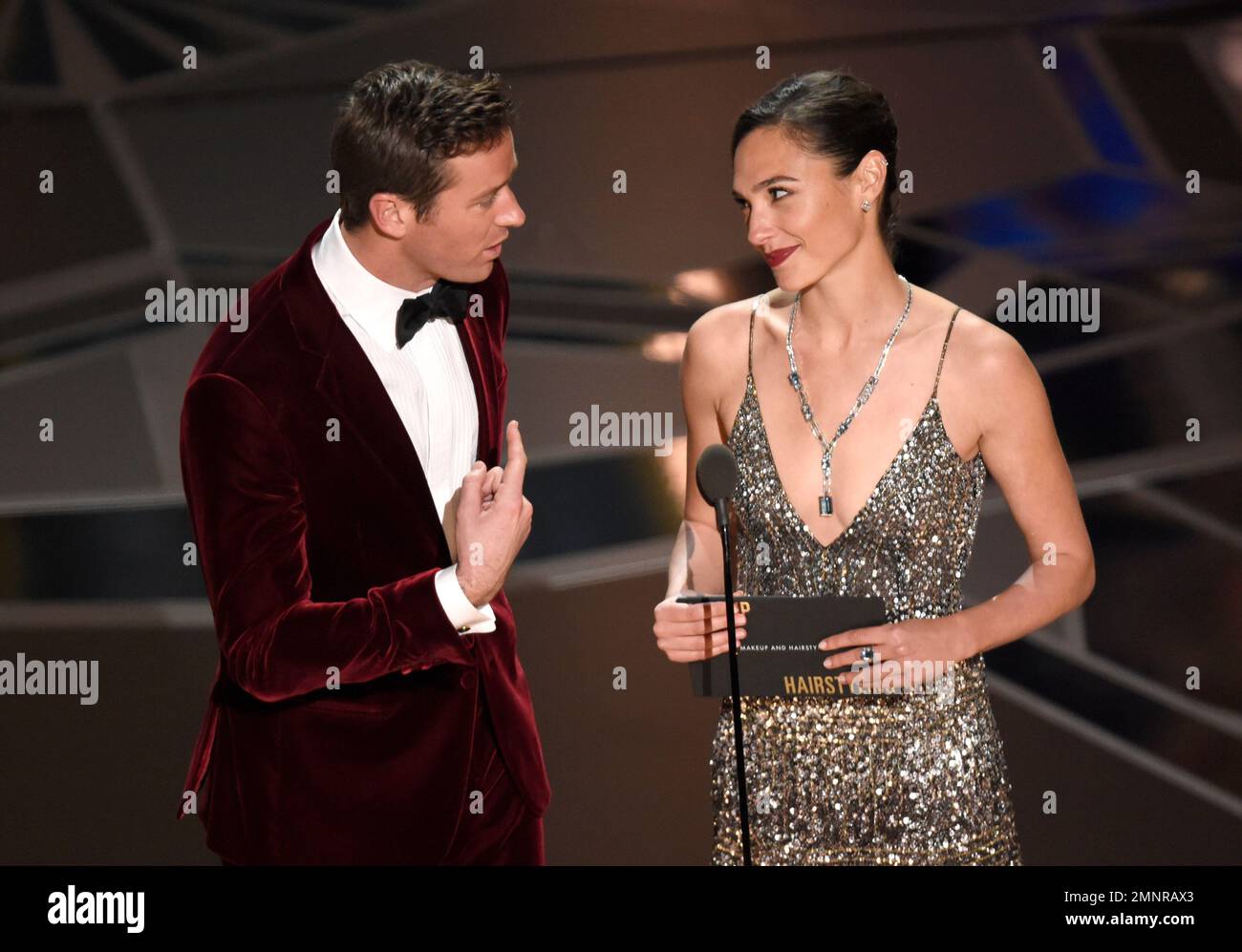 Armie Hammer, left, and Gal Gadot present the award for best makeup and ...
