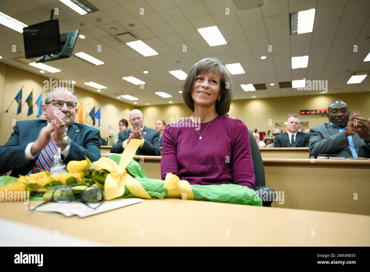 Erin Harter, wife of Maj. Gen. Bob D. Harter, receives a round of ...