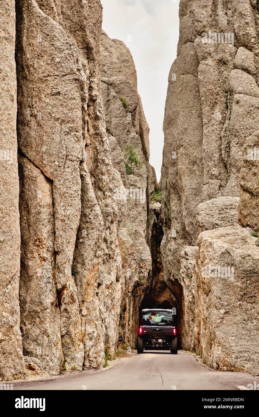 The narrow entrance between two towering stone spires Needles highway ...