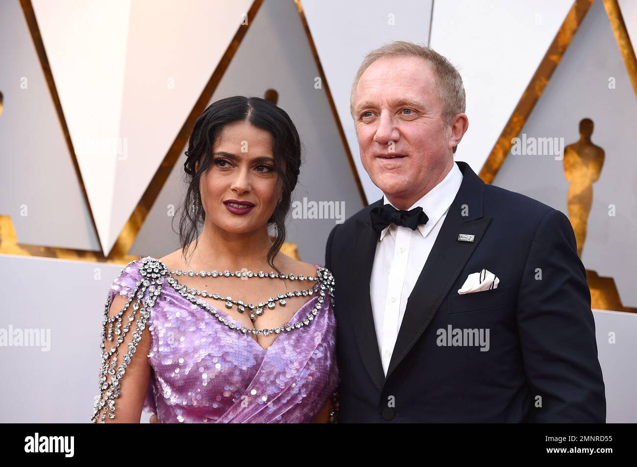 Salma Hayek, left, and Francois-Henri Pinault arrive at the Oscars on ...