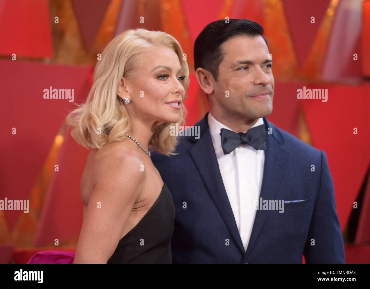 Kelly Ripa, left, and Mark Consuelos arrive at the Oscars on Sunday ...