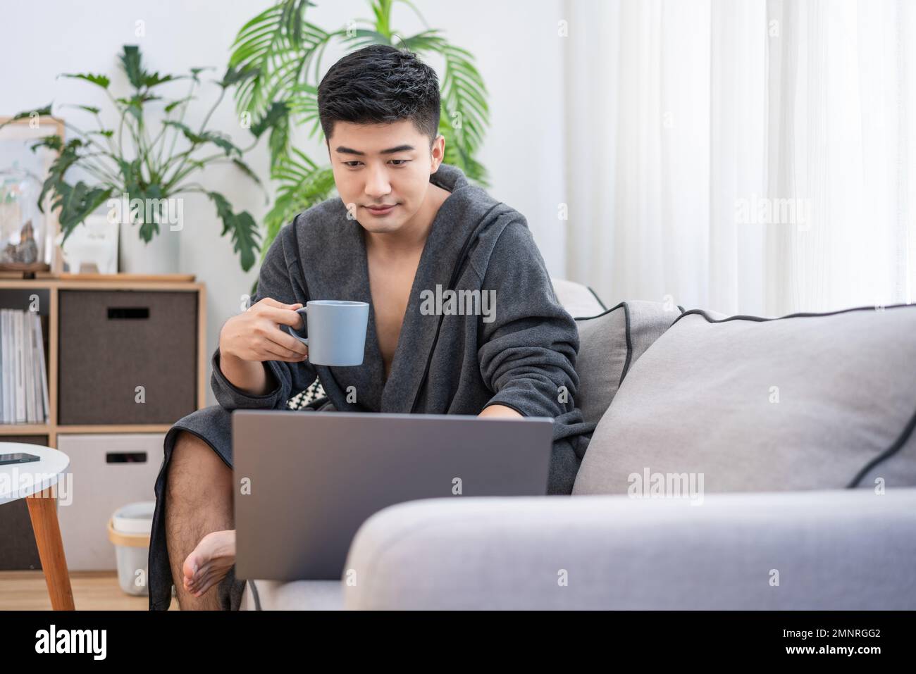 The young man to use a computer at home Stock Photo - Alamy