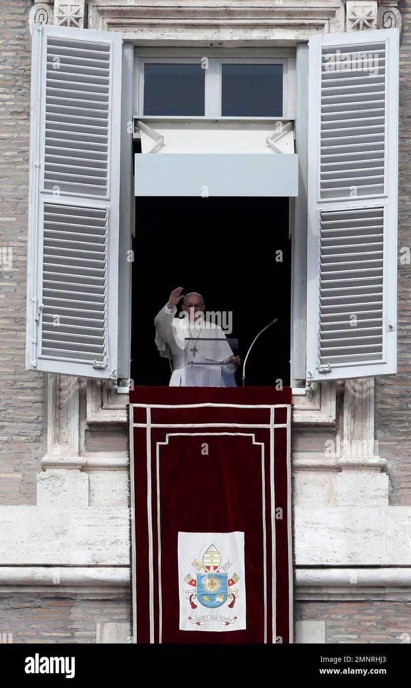 Pope Francis waves as he arrives to recite the Angelus noon prayer from ...