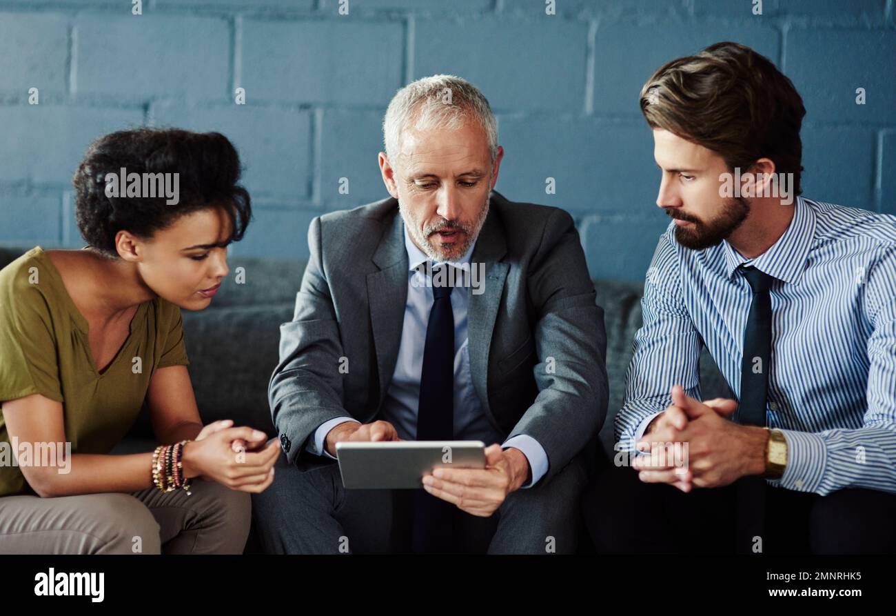 Teamwork is a big part of their company ethos. three businesspeople ...