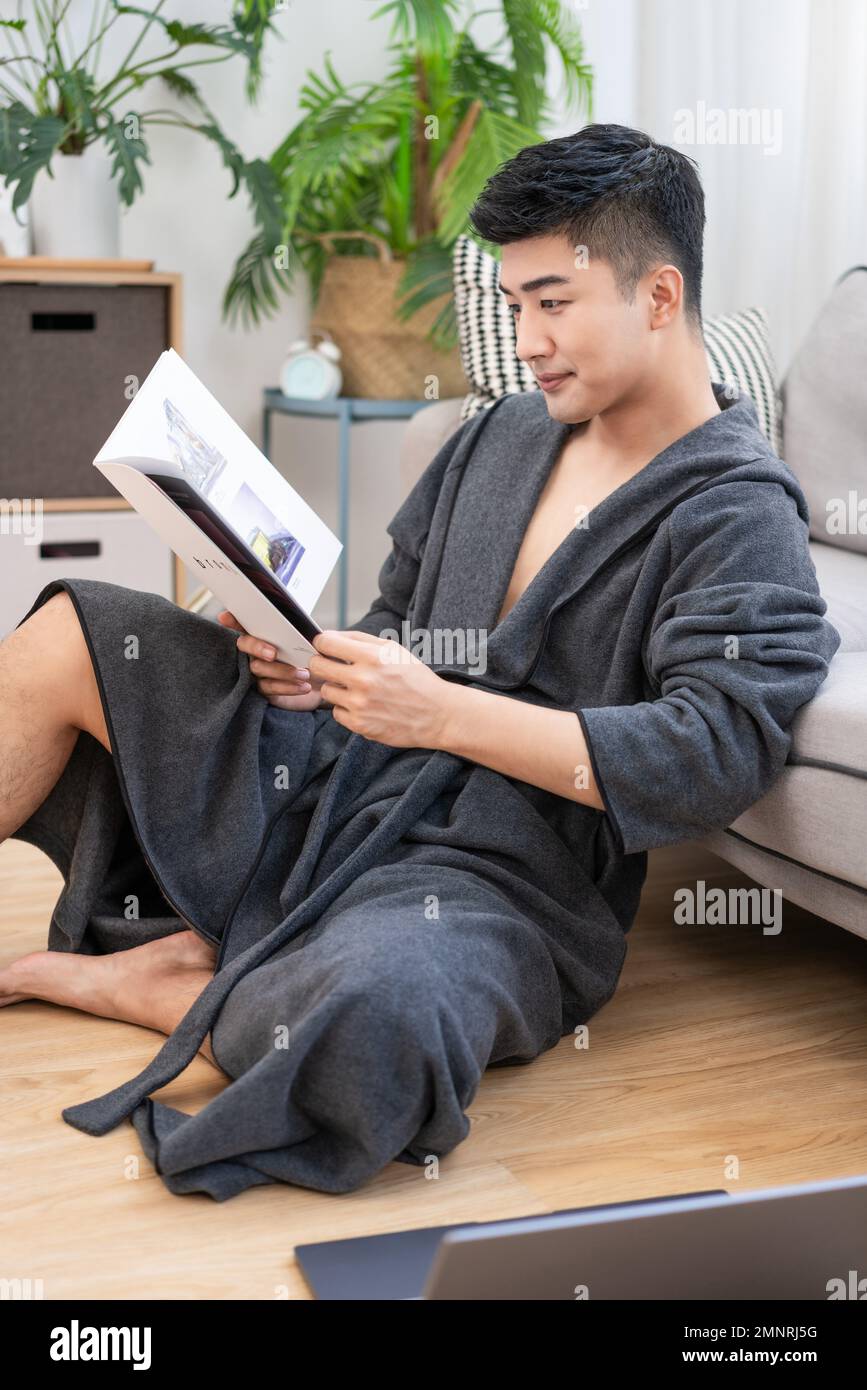The young man reading a book at home Stock Photo - Alamy