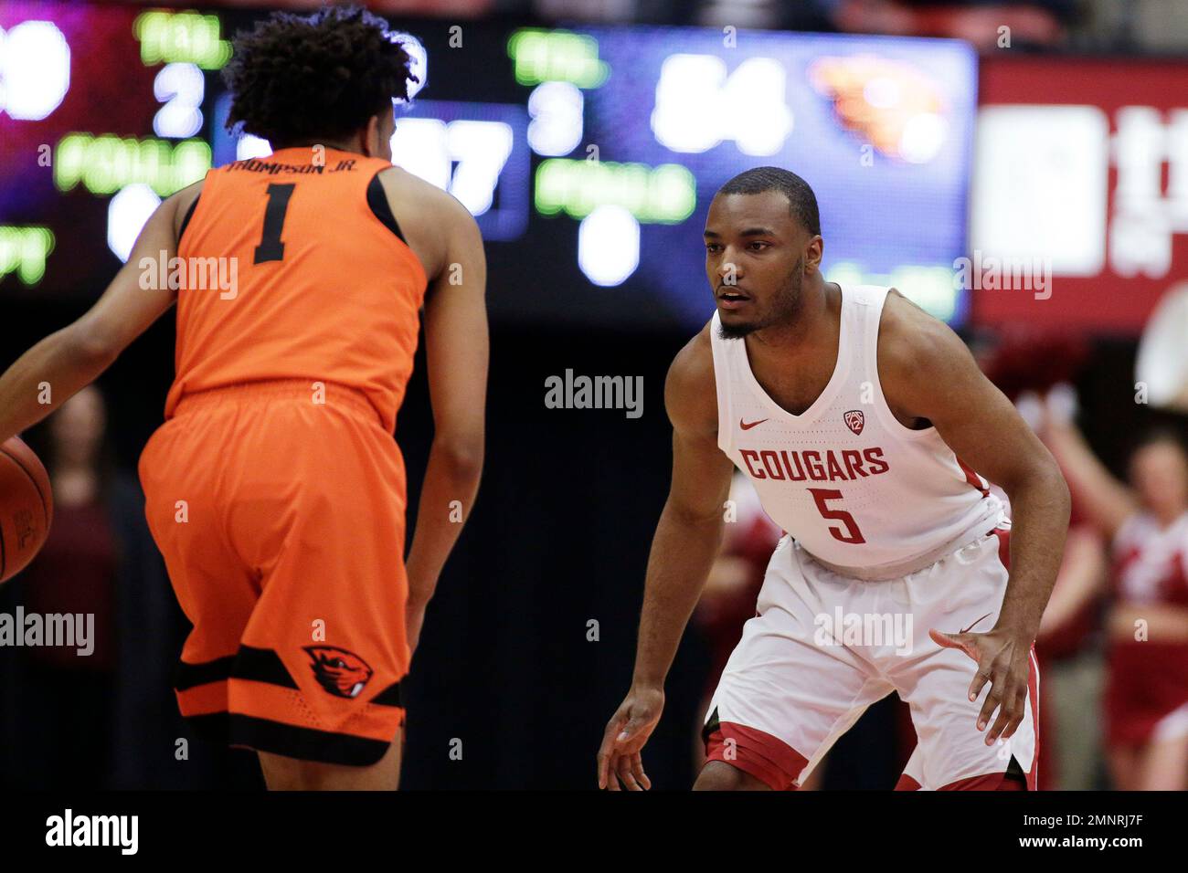 Washington State guard Milan Acquaah (5) defends Oregon State guard Stephen Thompson Jr. (1 ...