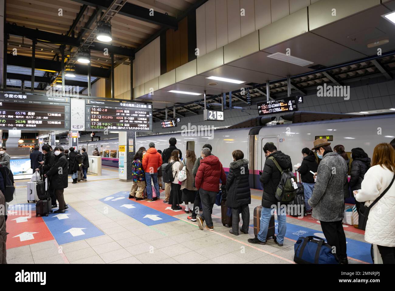 Tokyo, Japan. 27th Jan, 2023. Passengers queue in line for a delayed ...