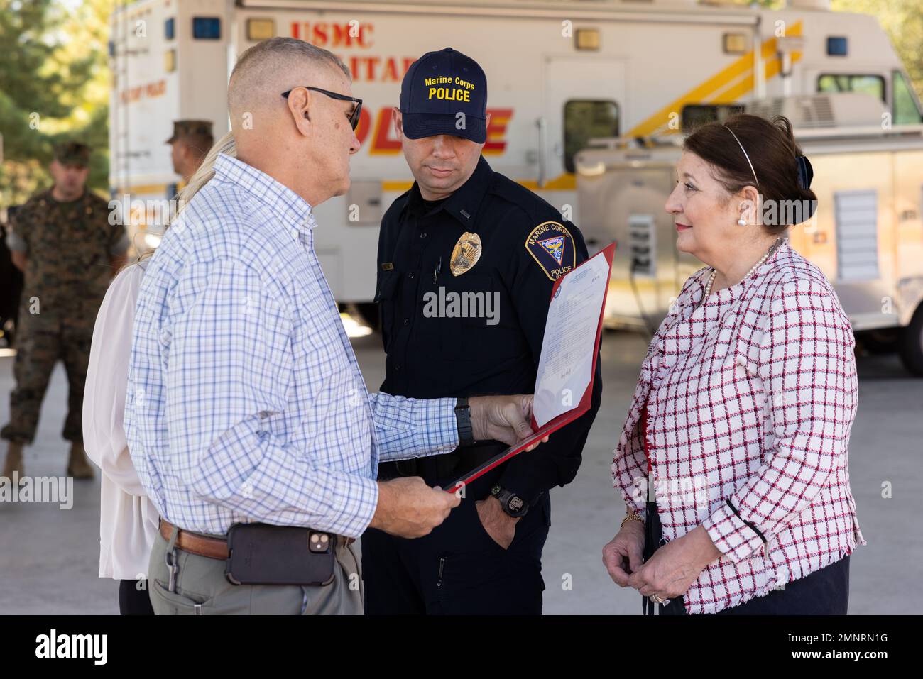 Family members read the award citation for Timothy Helm, middle, police ...