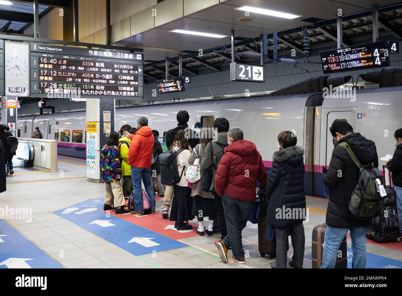 Tokyo, Japan. 27th Jan, 2023. Passengers queue in line for a delayed ...