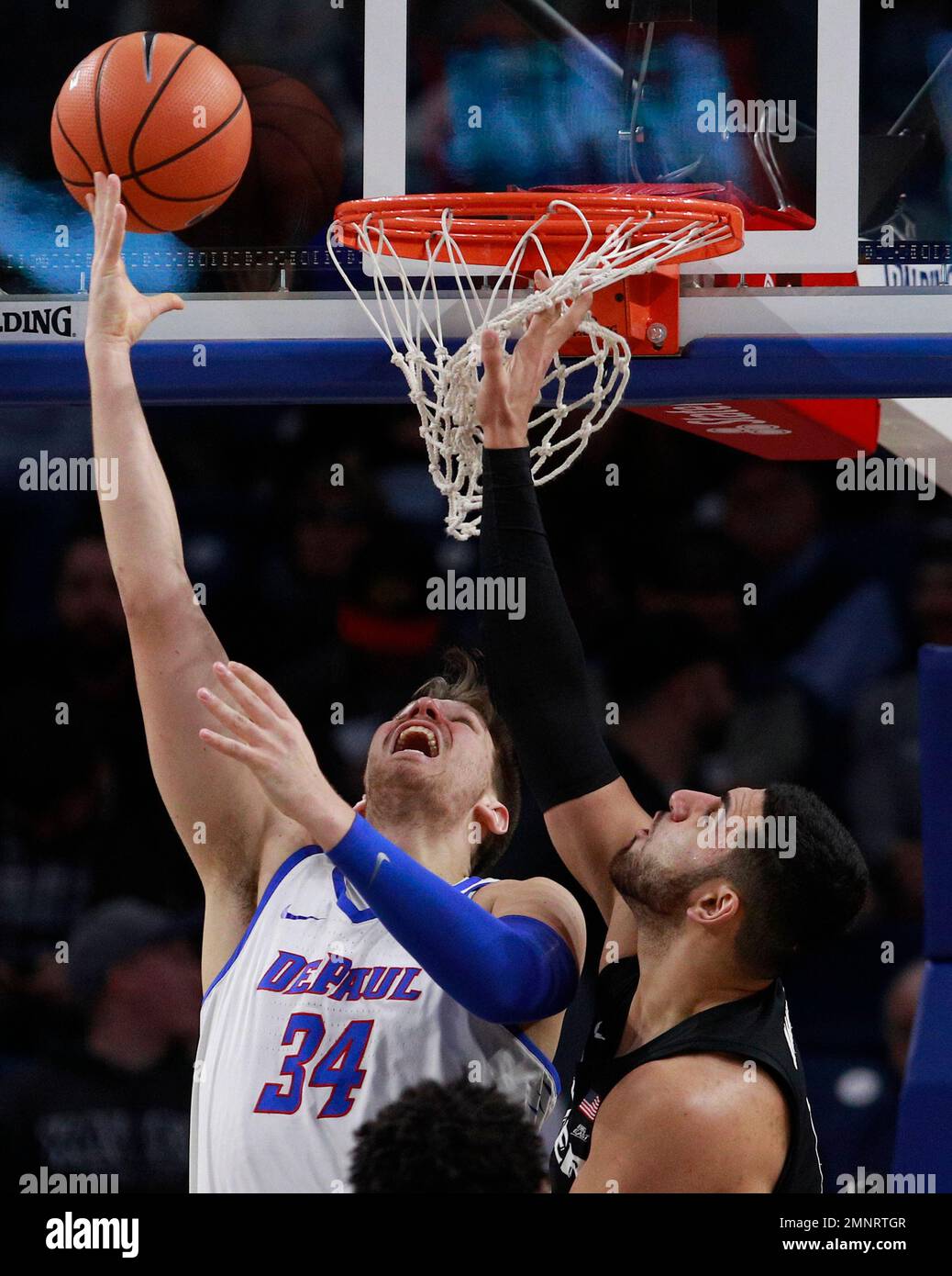 DePaul center Marin Maric (34), left, goes to the basket against Xavier ...