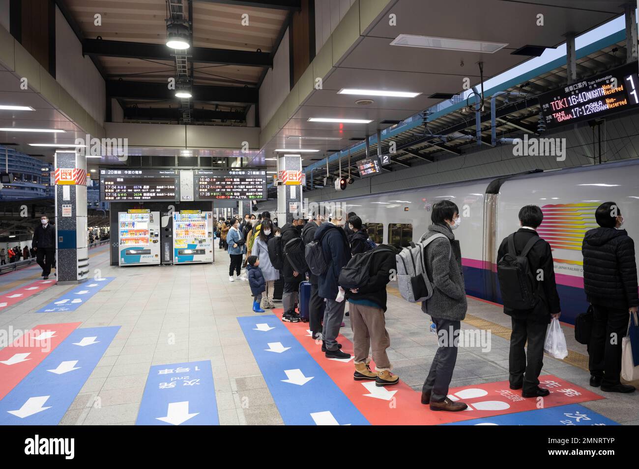 Tokyo, Japan. 27th Jan, 2023. Passengers queue in line for a delayed ...