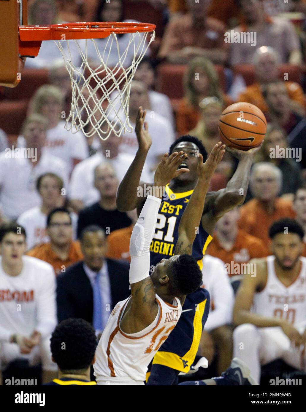 West Virginia forward Wesley Harris (21) puts up a shot over Texas ...