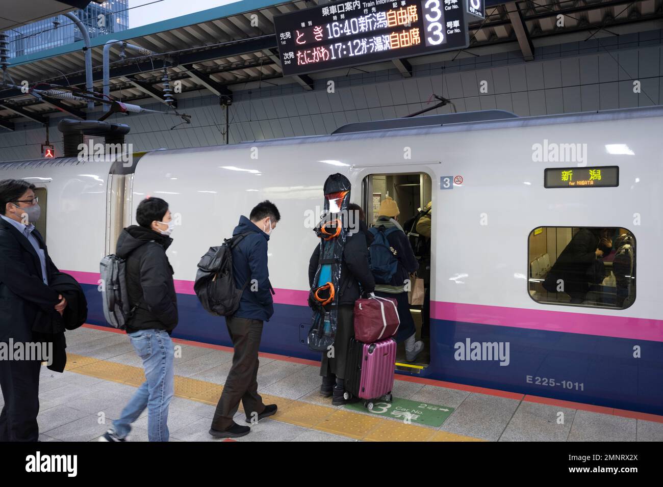 Tokyo, Japan. 27th Jan, 2023. Passengers queue in line for a delayed ...