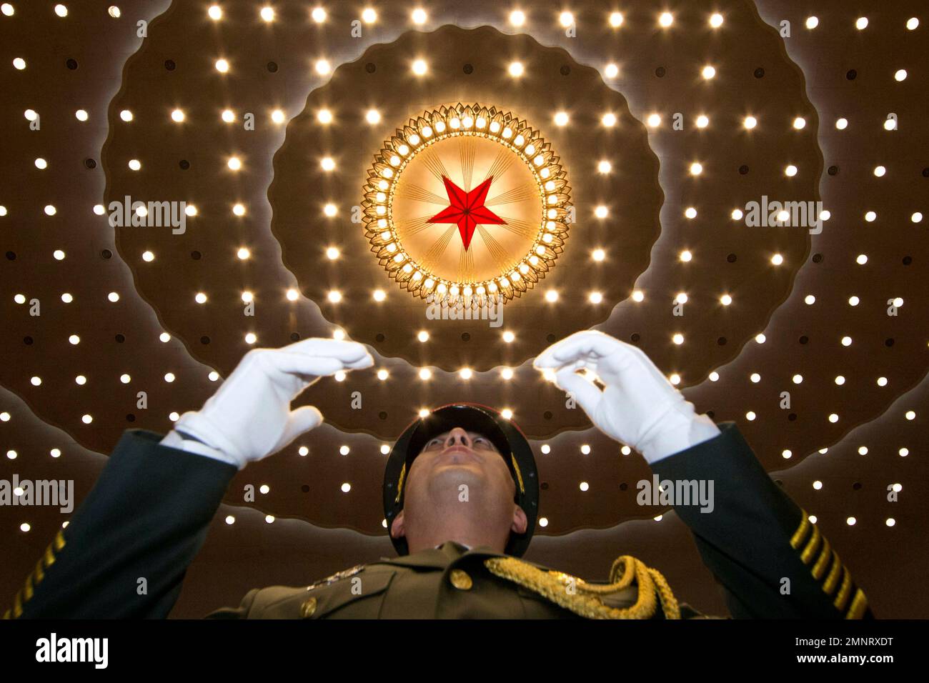A military band conductor leads the band at the opening session of the ...