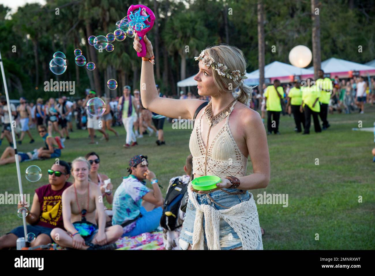 A festival-goer creates bubbles at the Okeechobee Music and Arts ...