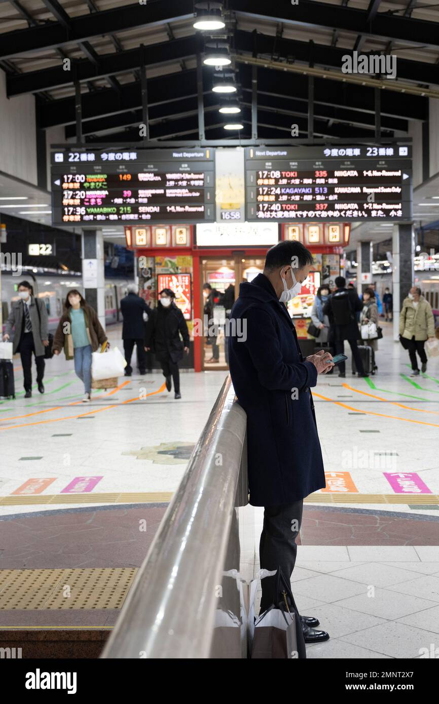 Tokyo, Japan. 27th Jan, 2023. Commuters and passengers wait on the ...