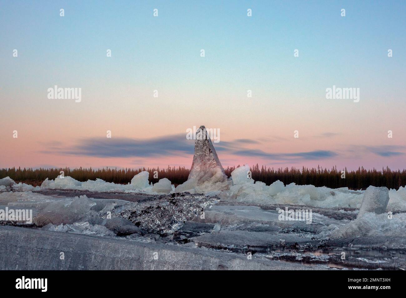 An ice floe in the form of a shark's fin sticks out of the surface of ...