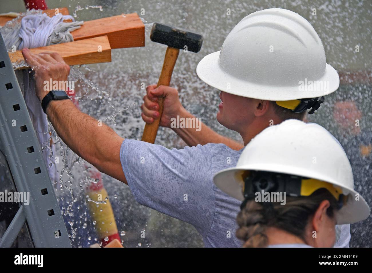 A student hammers a wedge into a mock, ruptured object to prevent more ...
