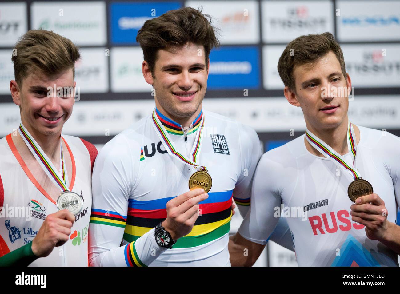 World champion Filippo Ganna of Italy, center, silver medalist Ivo Oliveira of Portugal, left ...