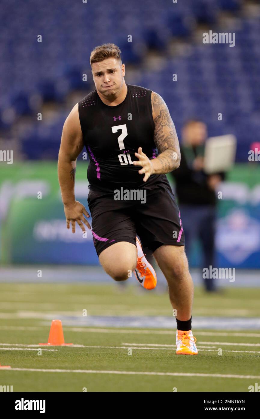 Michigan offensive lineman Mason Cole runs a drill at the NFL football ...