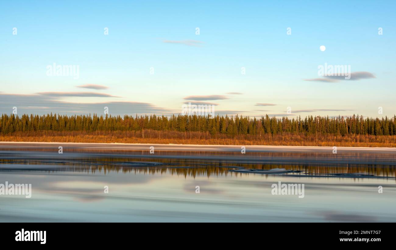 An ice floe floats on the Vilyui River in Yakutia against the backdrop ...