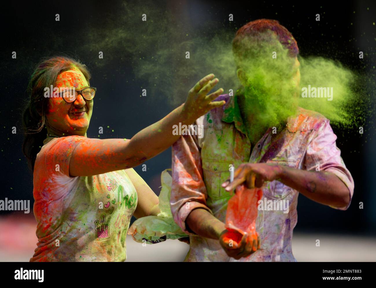 Indians throw colored powder on each other during Holi festival ...
