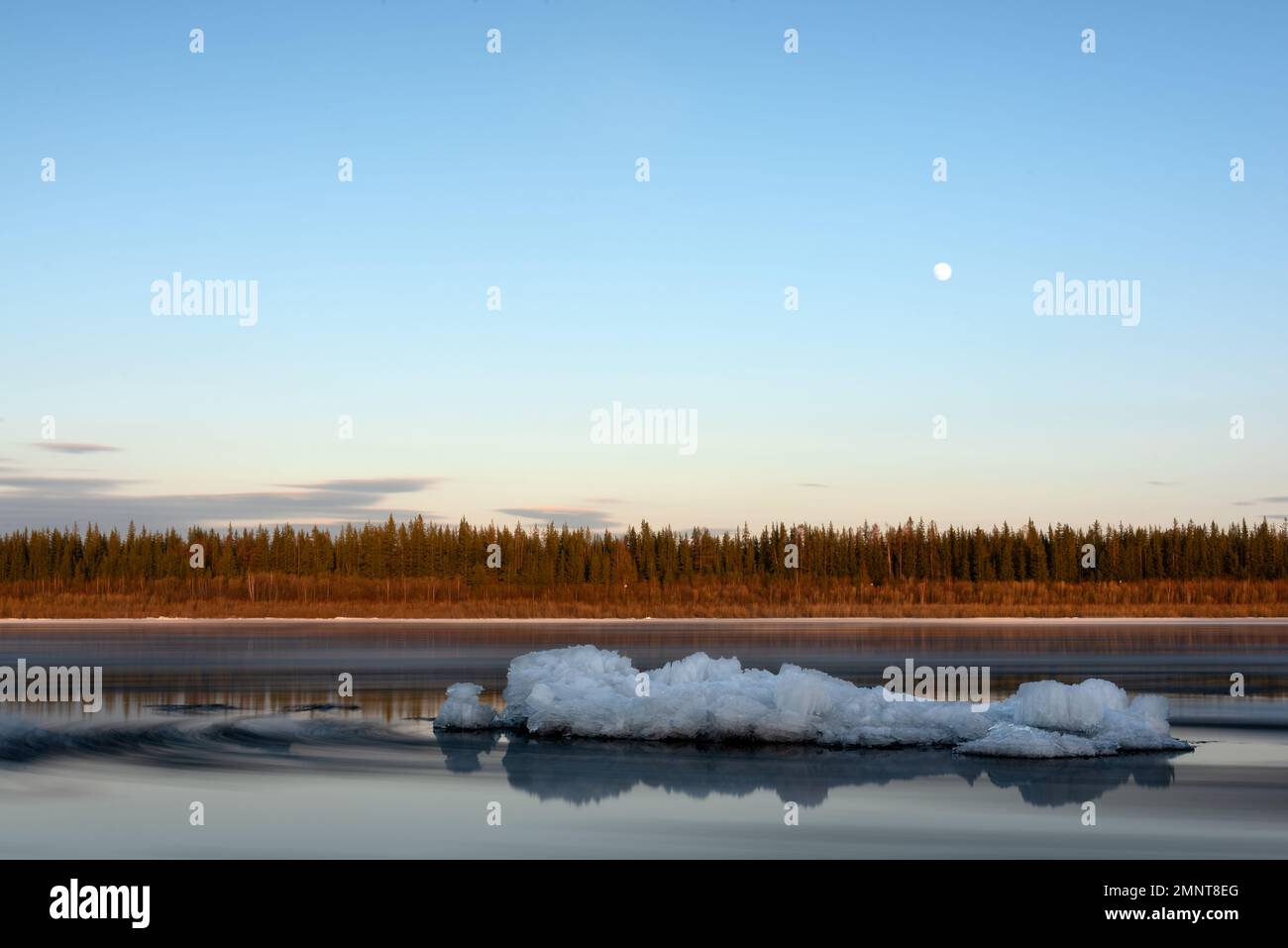 An ice floe lies on the Vilyui River in Yakutia against the backdrop of ...