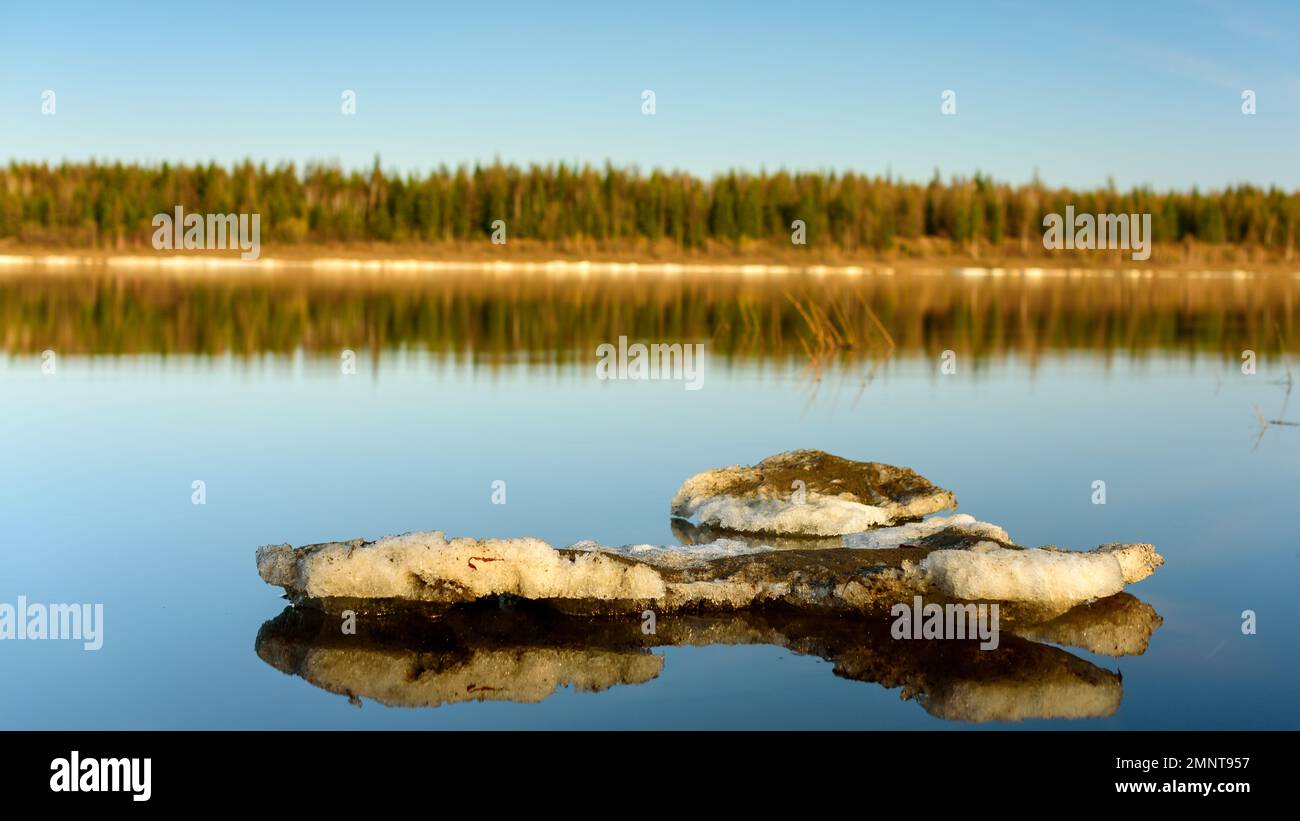 An ice floe lies on the Vilyui River in Yakutia against the backdrop of ...