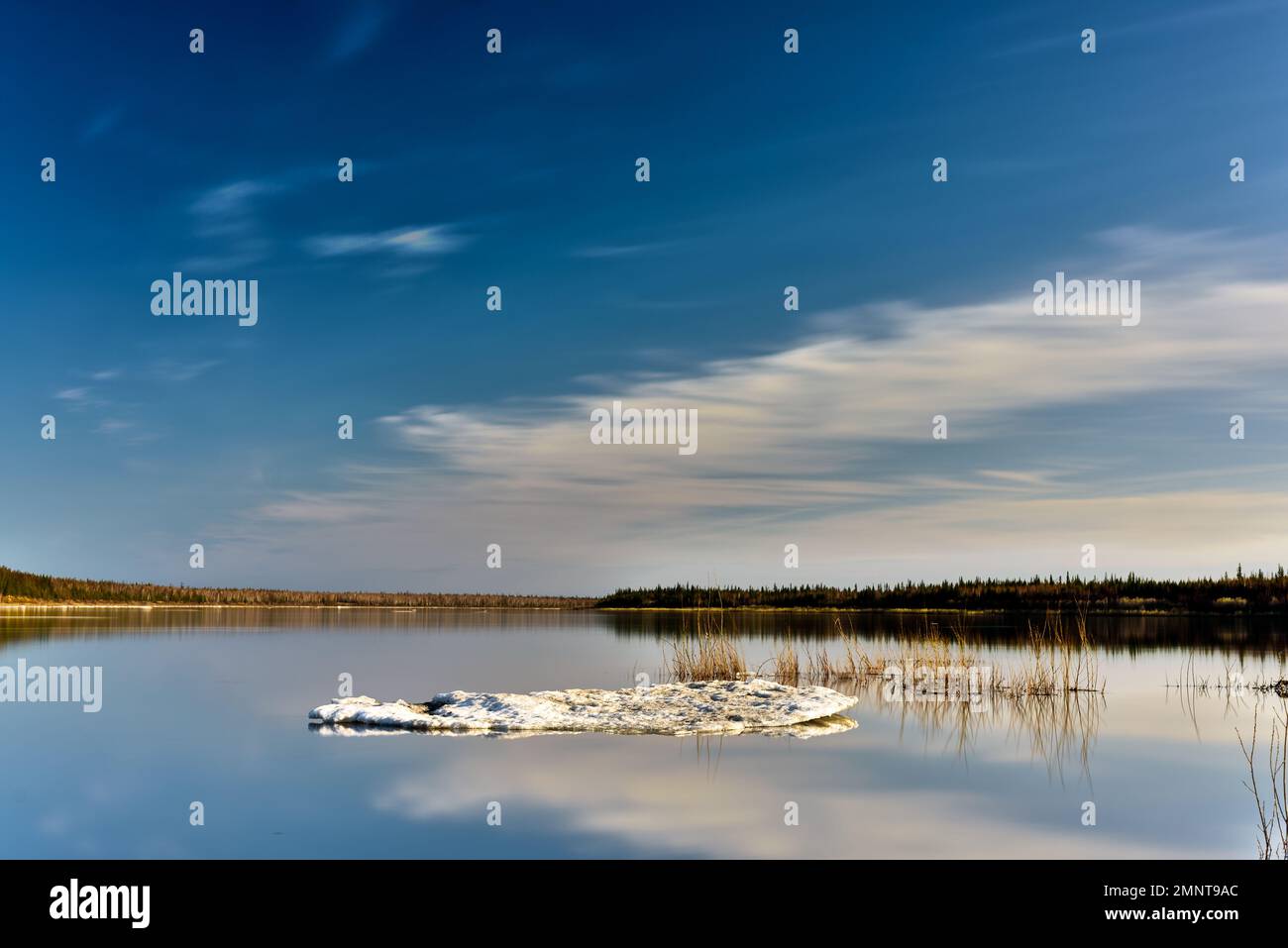 An ice floe lies on the Vilyui River in Yakutia against the backdrop of ...