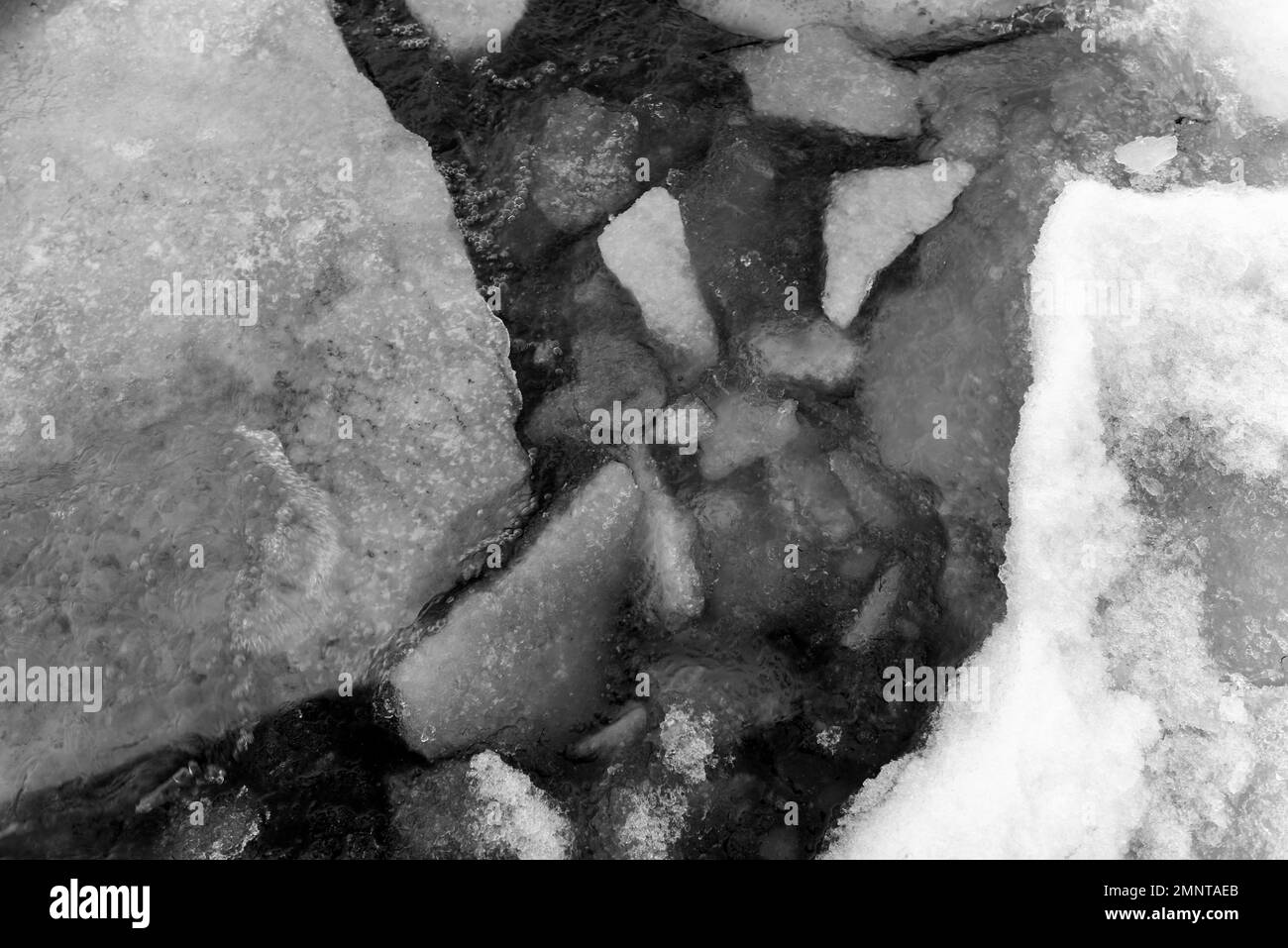 Texture of snow and cracked ice in winter sunlight Stock Photo - Alamy