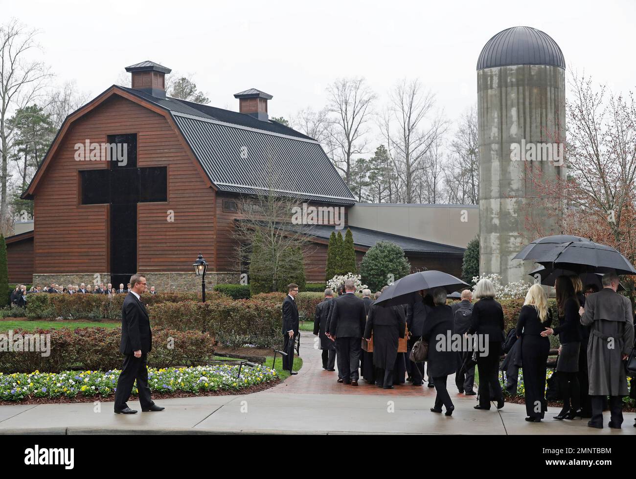 Family members follow behind as pallbearers carry the casket of the Rev ...