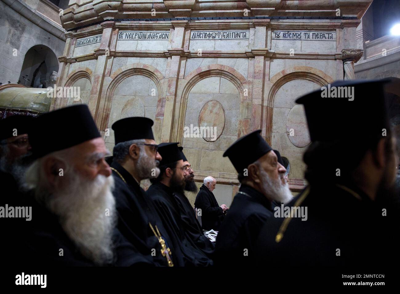 In this Wednesday, March 22, 2017 photo, Christian priests sits around ...