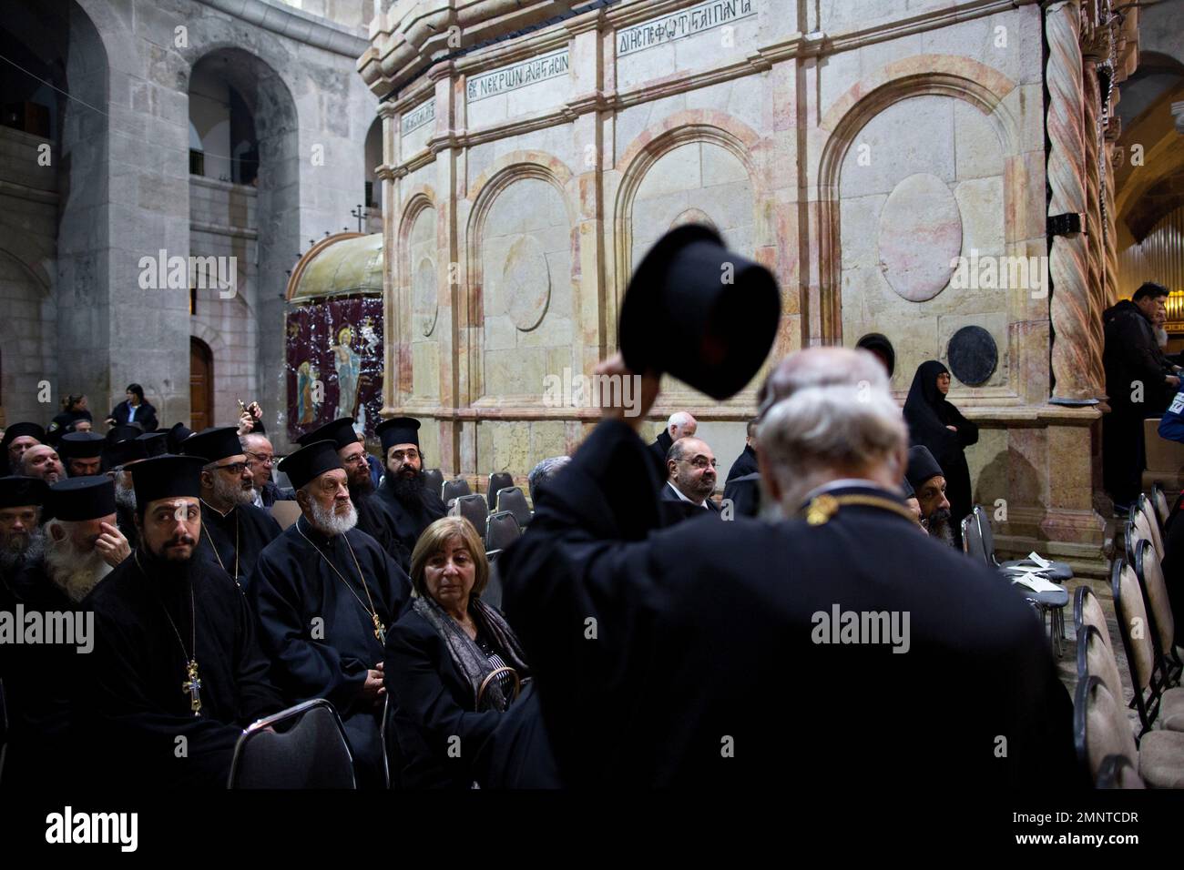 In this Wednesday, March 22, 2017 photo, Christian priests sits around ...