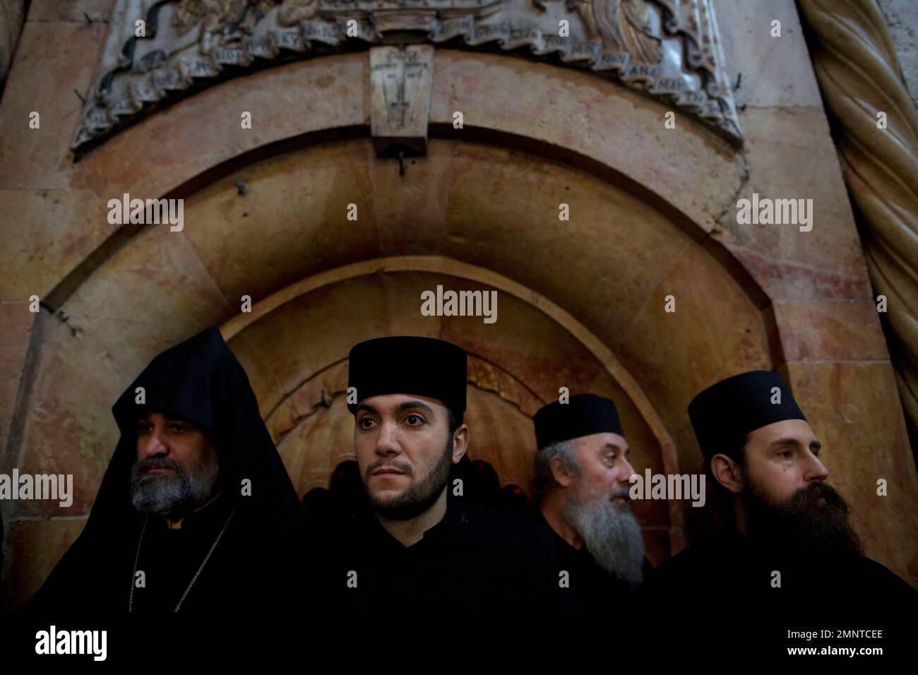 In this Wednesday, March 22, 2017 photo, Christian priests stand around ...