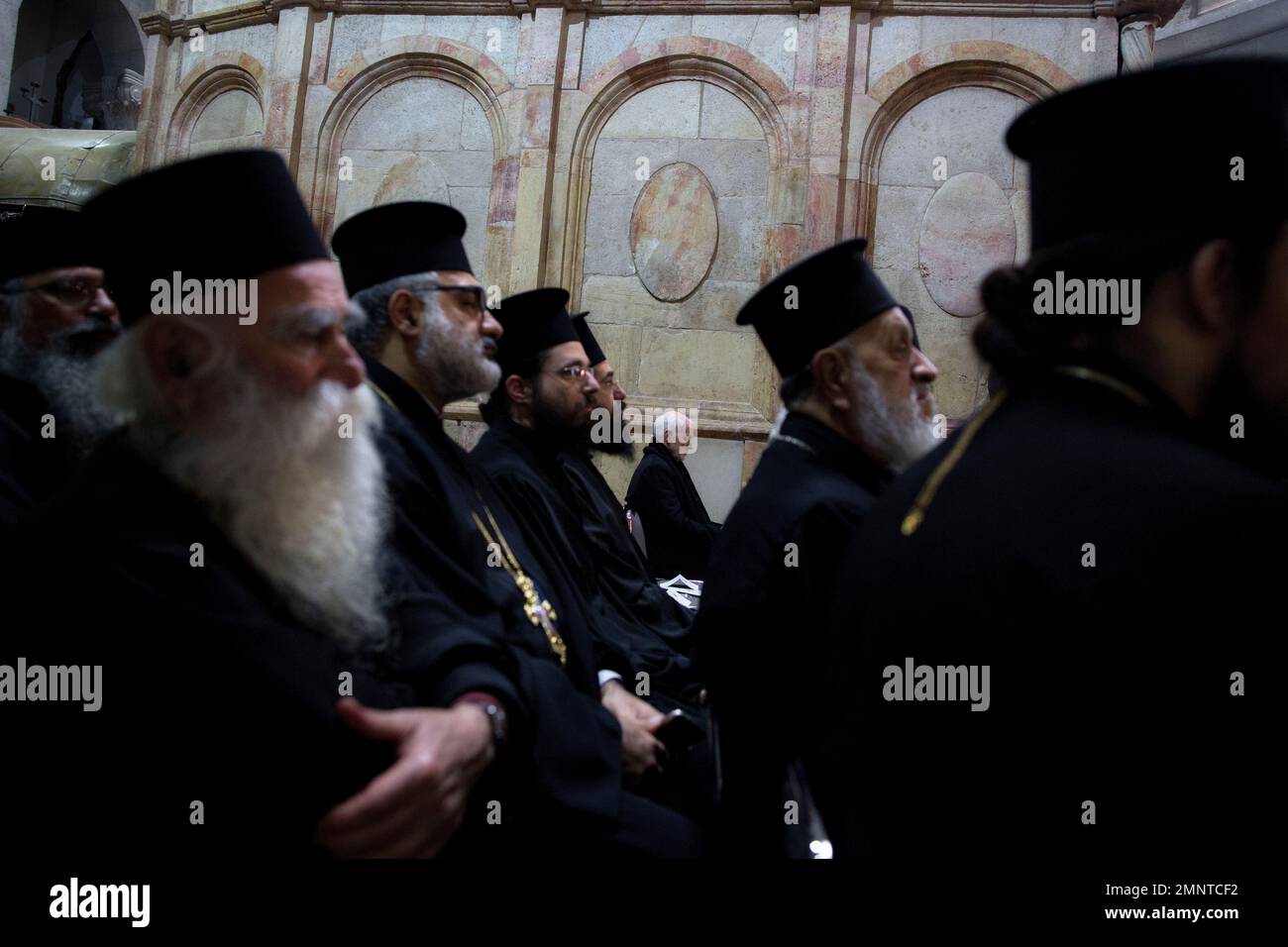 In this Wednesday, March 22, 2017 photo, Christian priests sits around ...