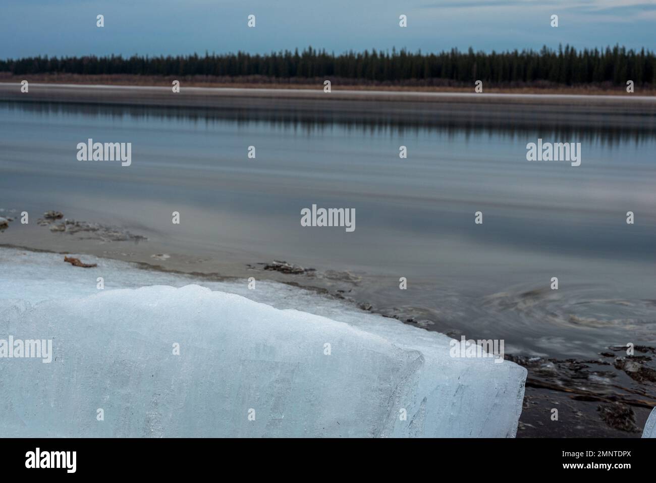 An ice floe lies on the banks of the Vilyui River in Yakutia against ...