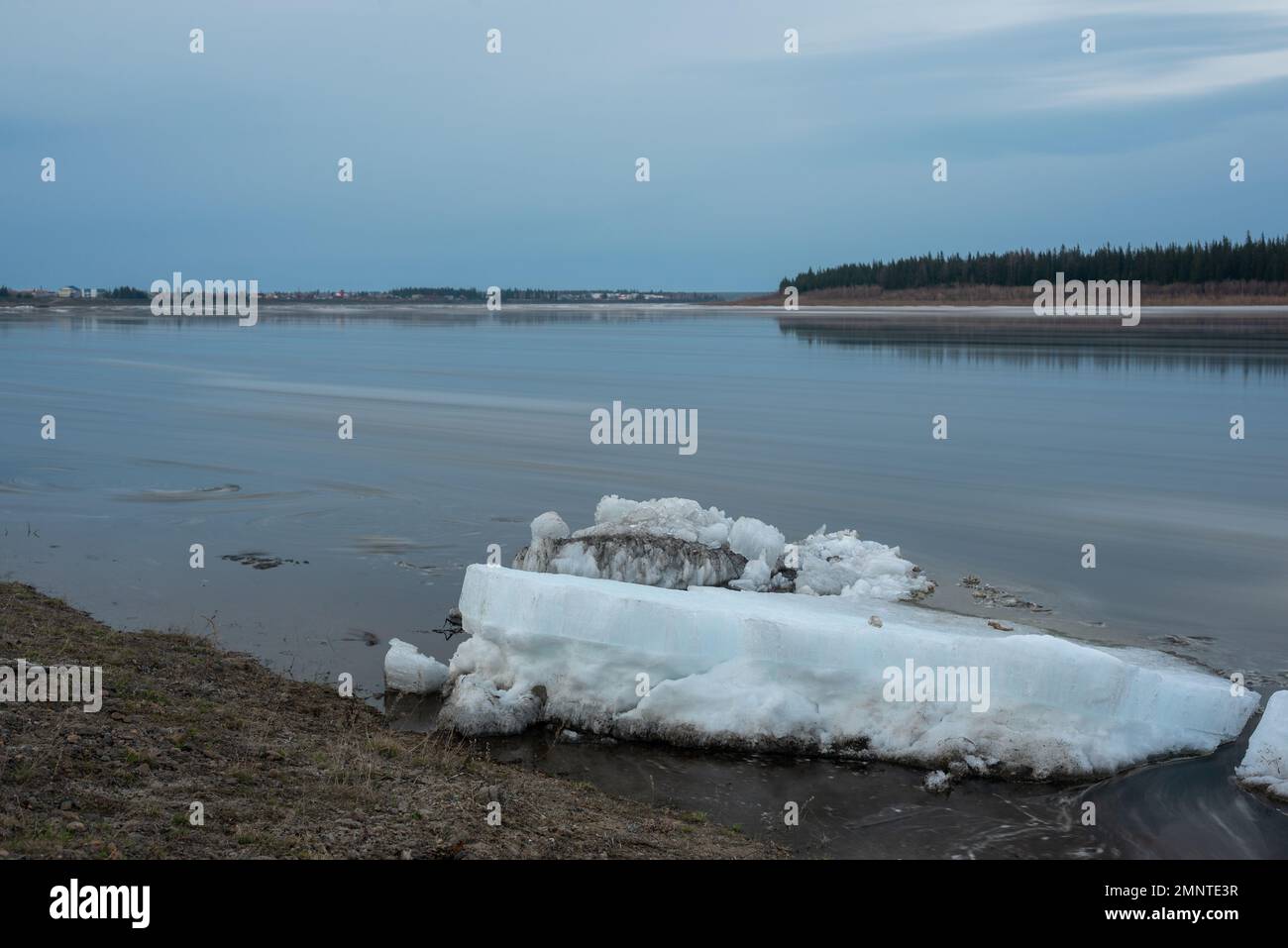 Ice floes lie on the banks of the Vilyui River in Yakutia against the ...