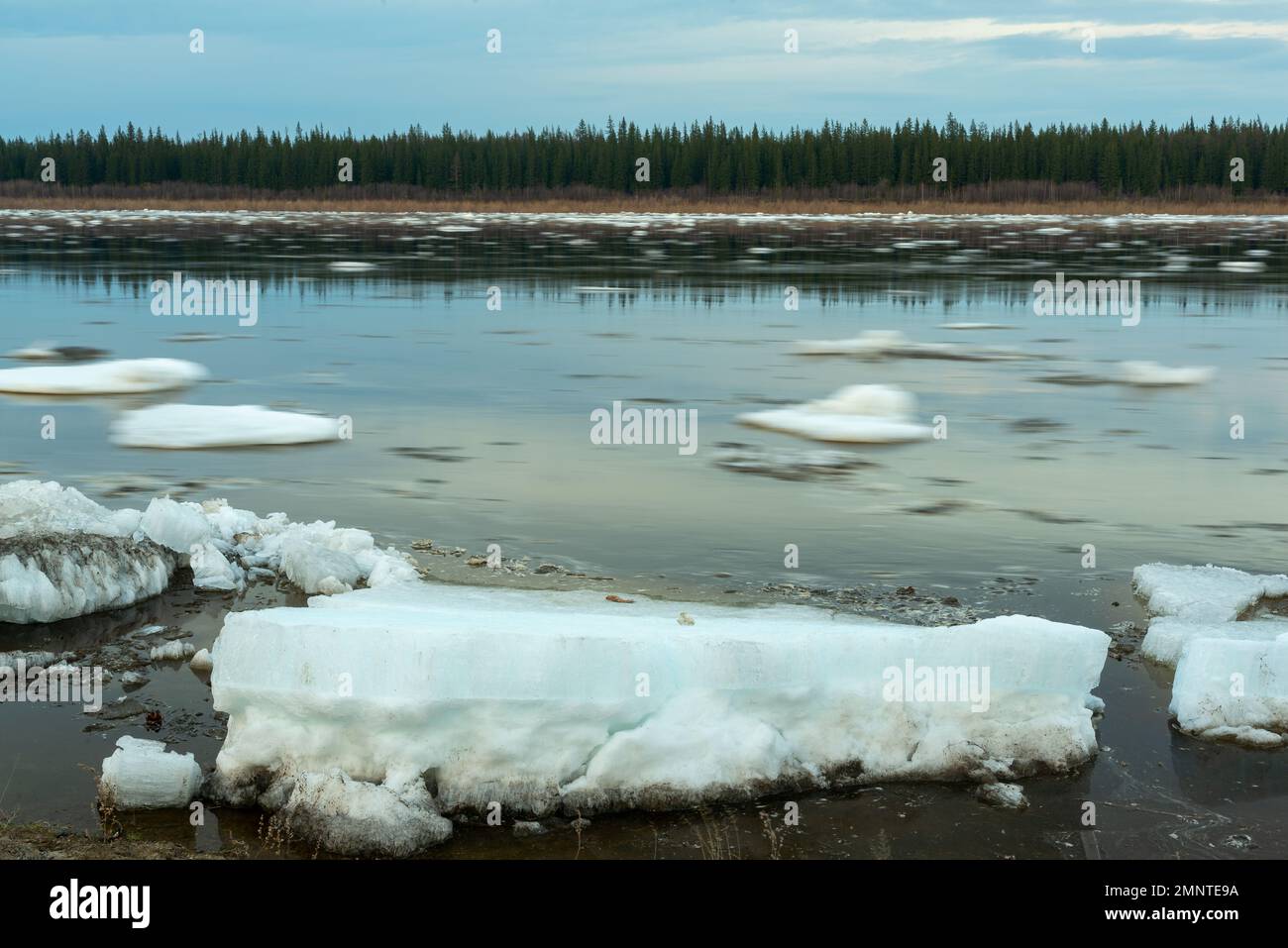 Ice floes lie on the banks of the Vilyui River in Yakutia against the ...